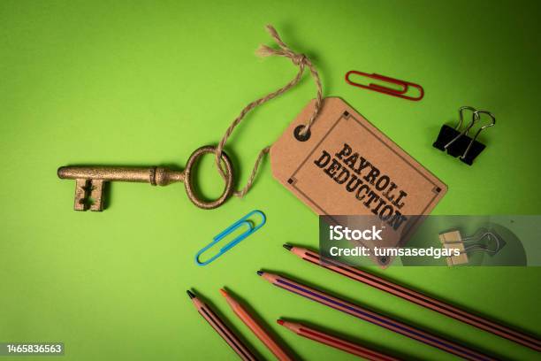 Payroll Deduction Golden Key With Price Tag On Green Office Table Stock