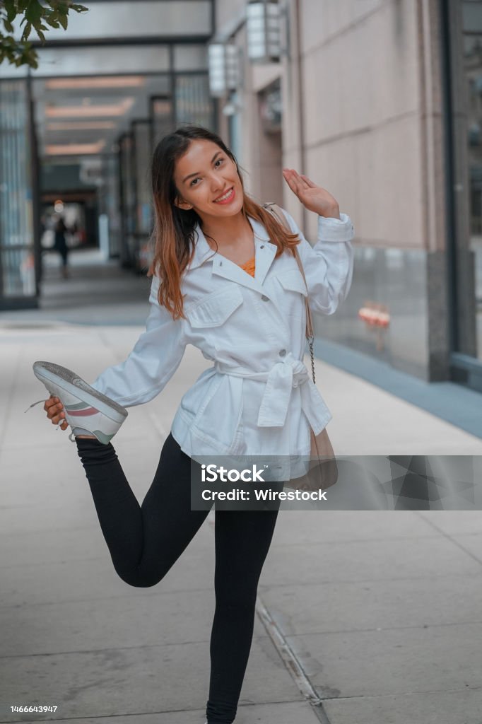 Vertical Of A Cheerful Stylish Young Beautiful Hispanic Female Posing