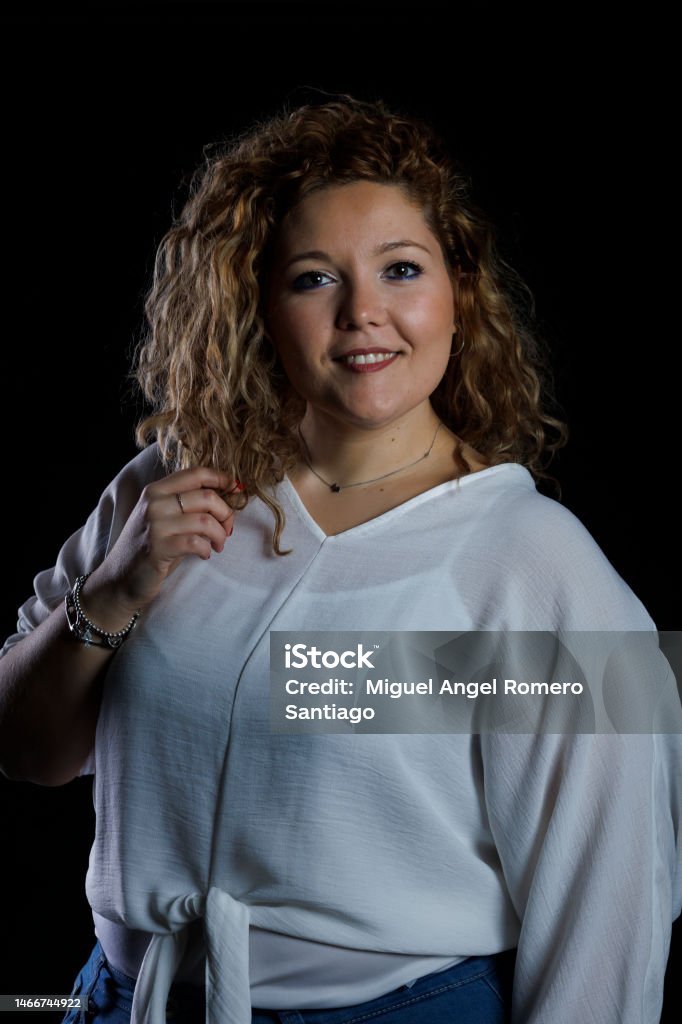 Plus Size Fashion Model In Denim Clothes And White Shirt On Black