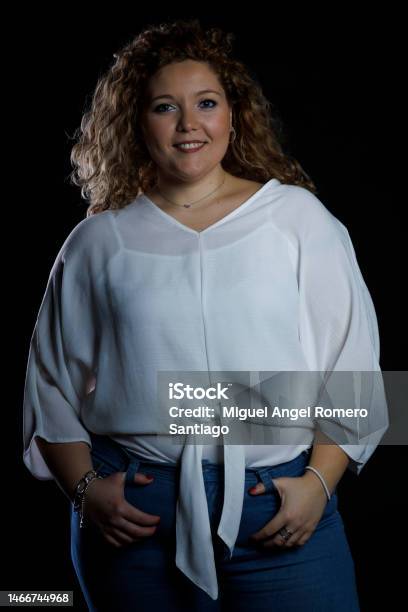 Plus Size Fashion Model In Denim Clothes And White Shirt On Black