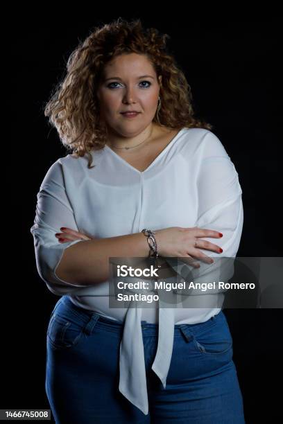 Plus Size Fashion Model In Denim Clothes And White Shirt On Black