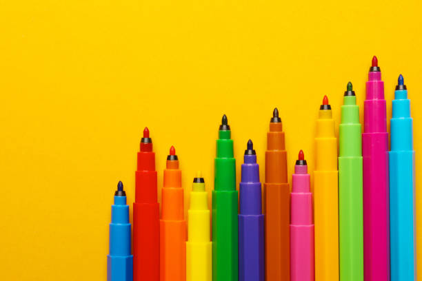 Free Stock Photo of A group of markers on a yellow and green background ...
