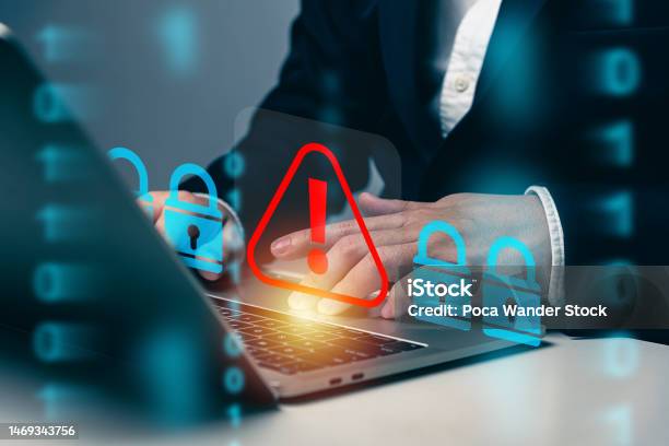 Businessman Or Programmer Using Laptop With Triangle Caution Warning