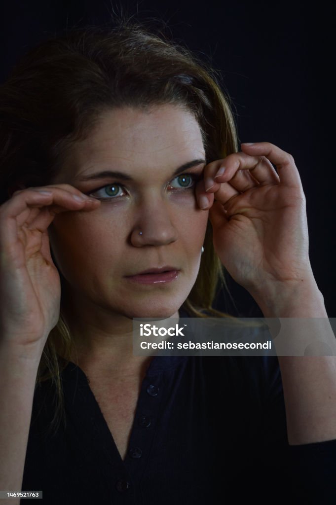 Portrait Of A Beautiful Blonde Woman Who Is Tired Rubs Her Eyes Trying
