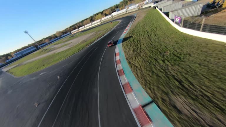 A Dynamic Tilting Aerial Shot While Tracking A Running Race Car Passing ... A Dynamic Tilting Aerial Shot While Tracking A Running Race Car Passing ...