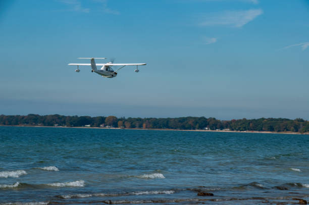 Free Stock Photo of Small Plane Flying Over Large Body of Water ...
