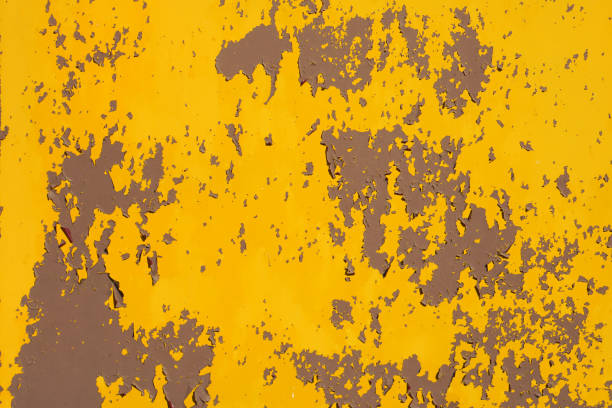 Free picture: Vivid yellow paint peeling off from a rough concrete surface