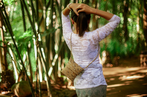 Asian Girl Wearing White Traditional Kebaya And Batik Sarong Showing