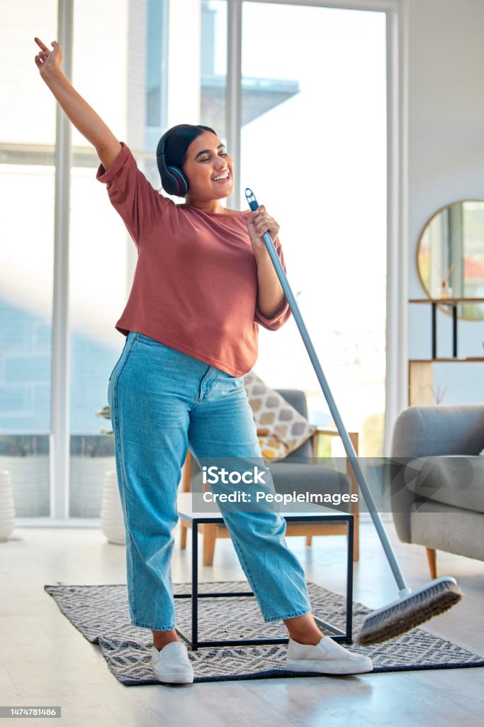 Woman Singing And Dancing While Cleaning Living Room For Fun Domestic