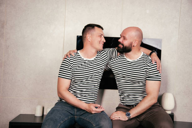 40 Mature Older Senior Gay Male Couple Smiling And Affectionate Stock