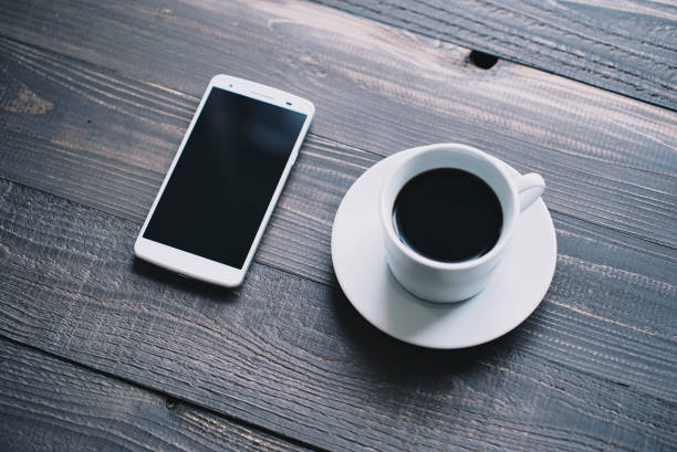 Free Stock Photo of Coffee Cup and Cell Phone on Table | Download Free ...