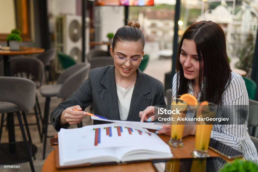 Female Bankers Comparing Calculations To Graphic Charts Inflation Rates ... Female Bankers Comparing Calculations To Graphic Charts Inflation Rates ...