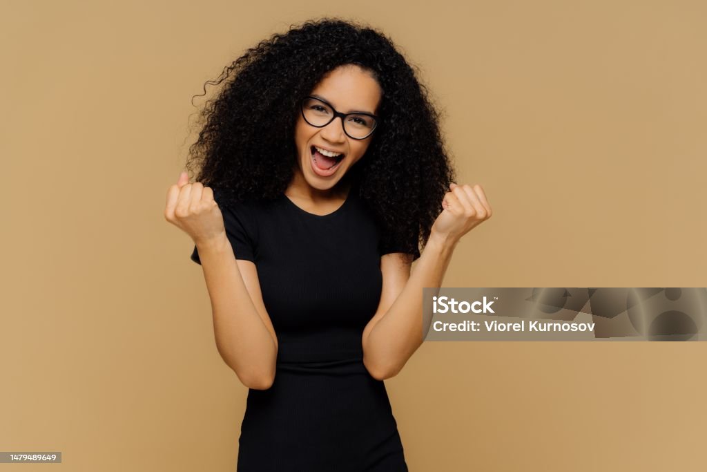 Triumphing Lovely Dark Skinned Woman Raises Clenched Fists Yells With