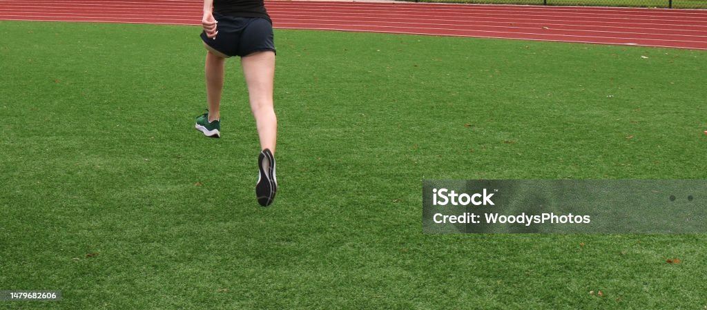 Runner In The Air Bounding On A Turf Field Stock Photo - Download Image ... Runner In The Air Bounding On A Turf Field Stock Photo - Download Image ...
