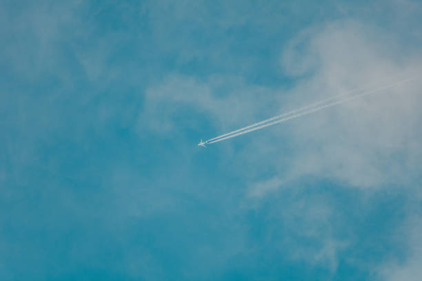 Free Stock Photo of A tall building with a jet trail in the sky ...