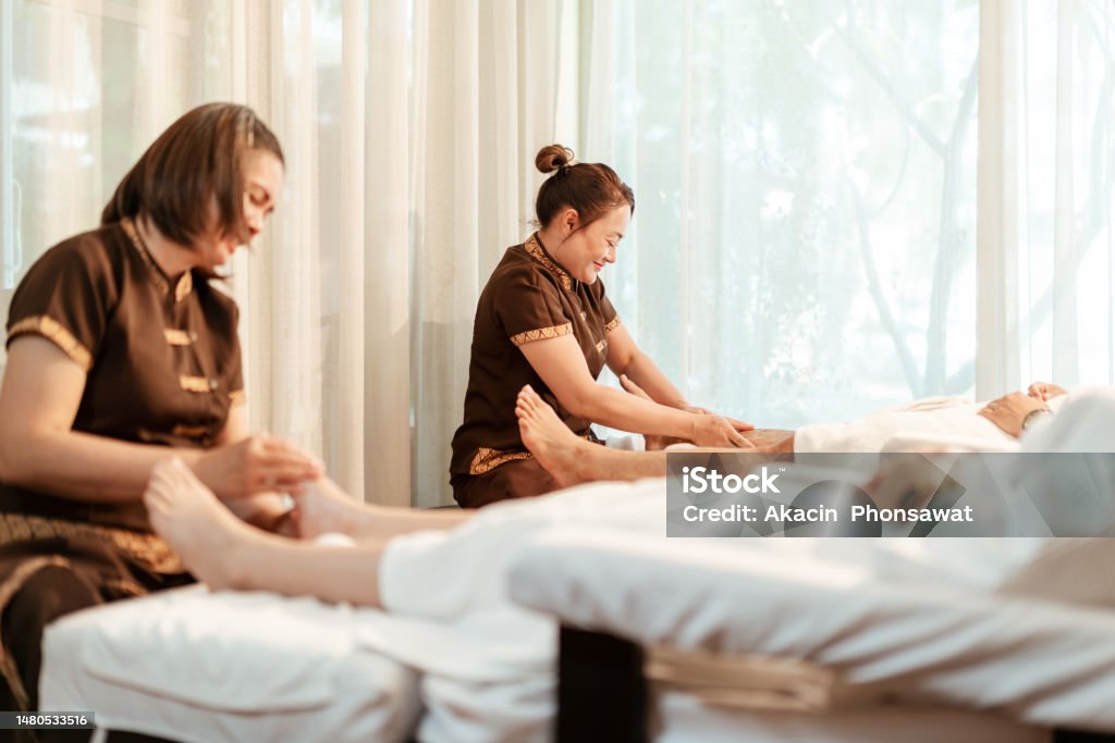 Masseuse Mature Asian Woman Working Massage Service In Spa Salon Foot Massage Customer Stock