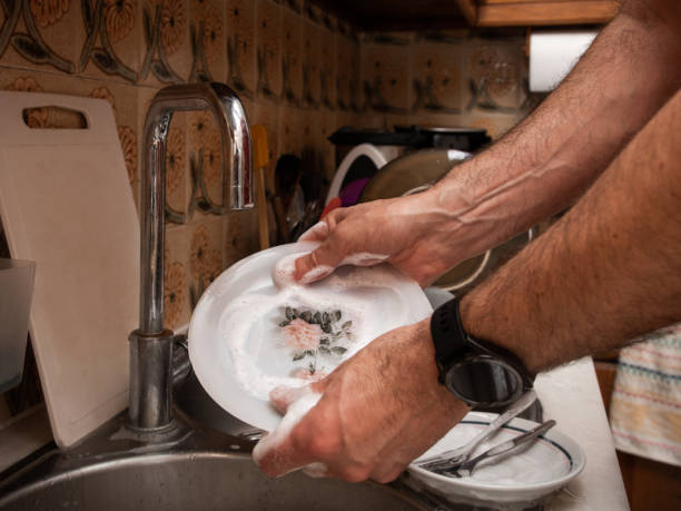 Free Stock Photo of Adult male washing dishes in the kitchen at home ...