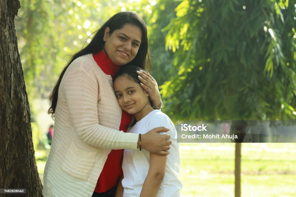 Happy And Loving Indian Mother And Daughter In The Public Park Hugging