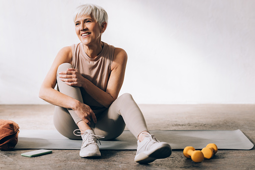 A Happy Beautiful Woman Looking Away After Doing Her Daily Workout At
