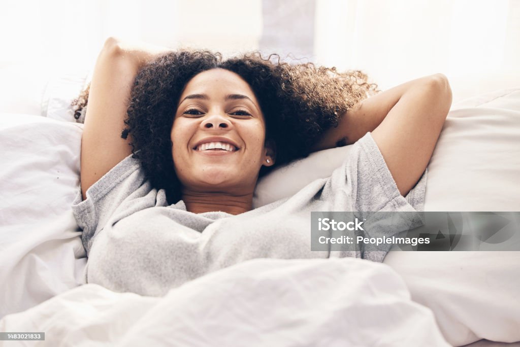 Black Woman Wake Up And Portrait In Home Bedroom After Sleeping Or