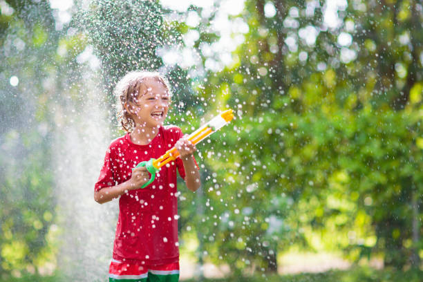Free Stock Photo of Young Boy Running Through a Sprinkle of Water ...