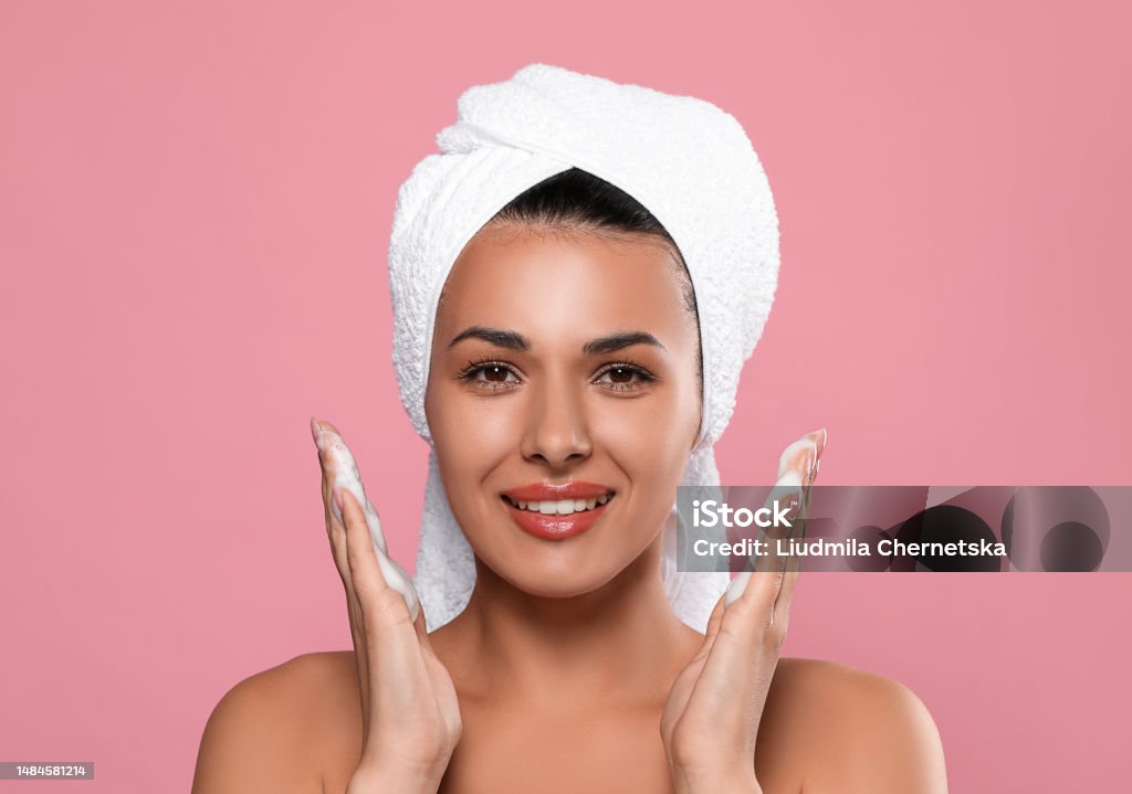 Beautiful Woman Applying Facial Cleansing Foam On Pink Background Stock