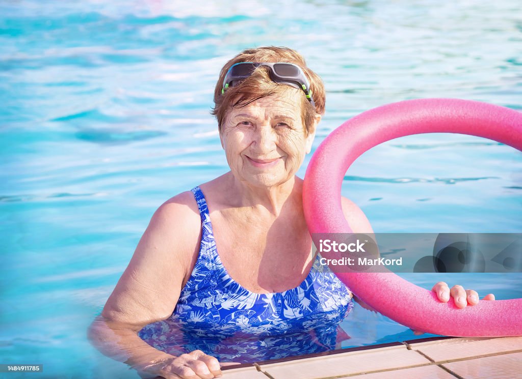Senior Women In Sport Goggles Swimsuit With Swim Noodles In Swimming