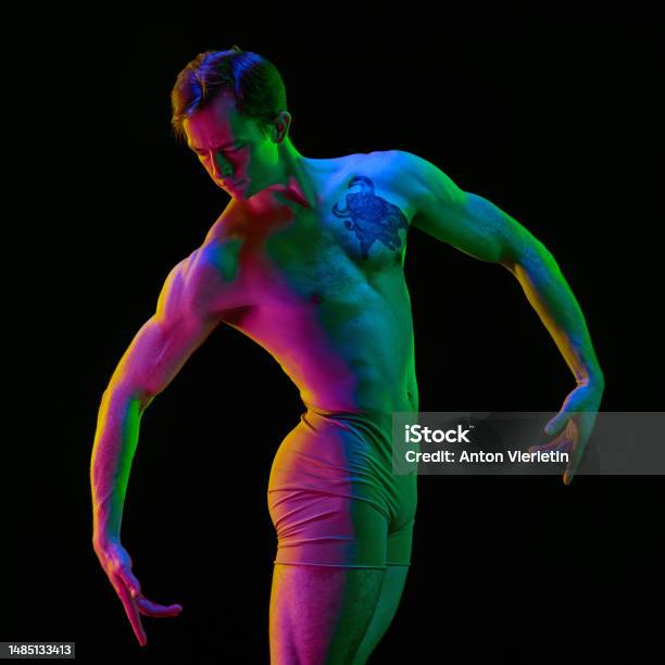 Portrait Of Graceful Muscled Male Ballet Dancer Dancing Over Dark
