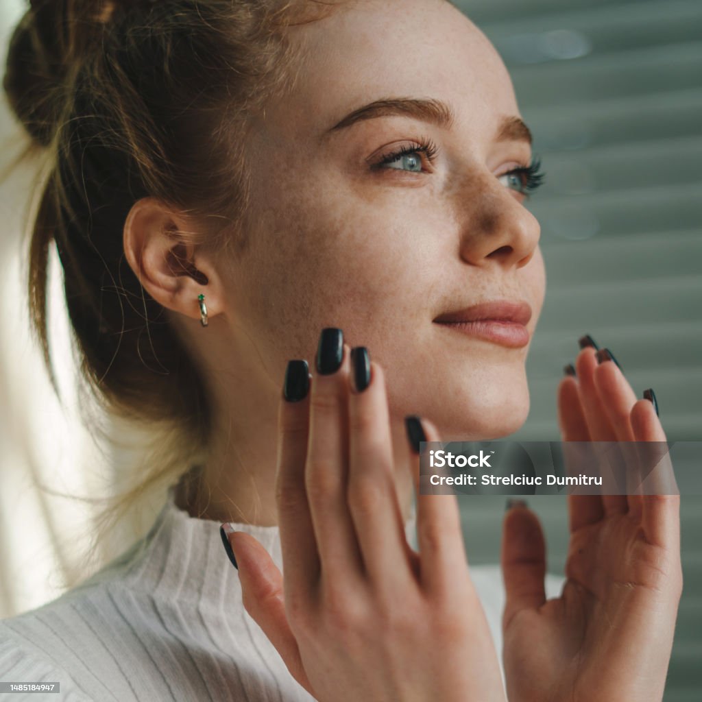 Closeup View Of A Beautiful Young Woman With Freckles Making Herself Face Massage Face Massage