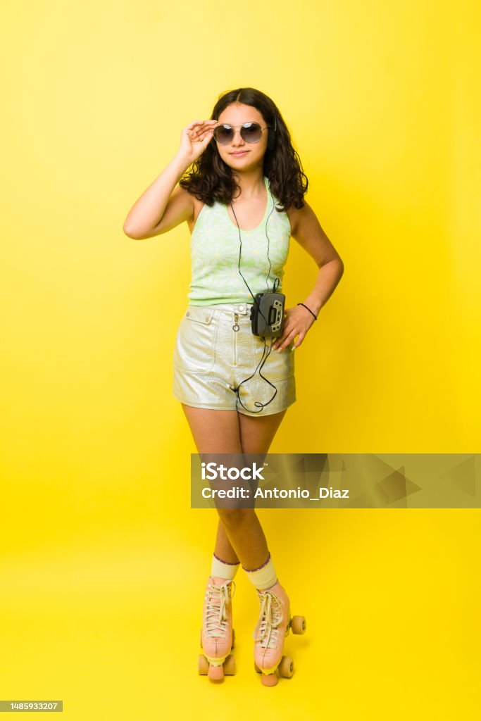 Full Length Of A Beautiful Teen Girl Using Vintage Roller Skates Stock