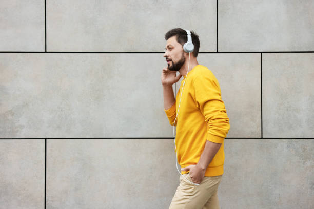 Free Stock Photo of Man Walking Down Street With Headphones On ...