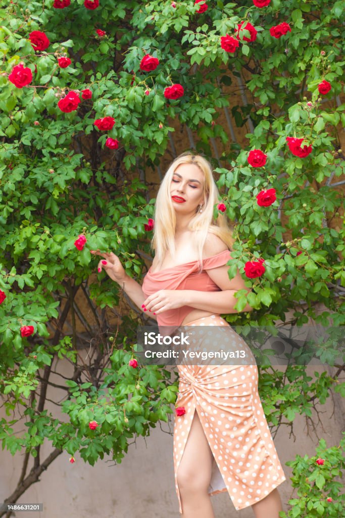 Beautiful Woman With Long Blonde Hair And Red Lips Wearing Pink Clothes