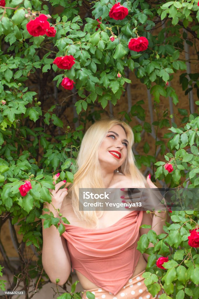 Beautiful Woman With Long Blonde Hair And Red Lips Wearing Pink Clothes