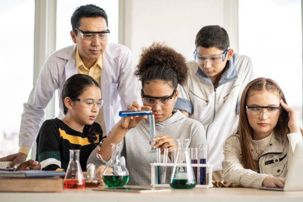 Free Stock Photo of Group of students watching teacher show science ...