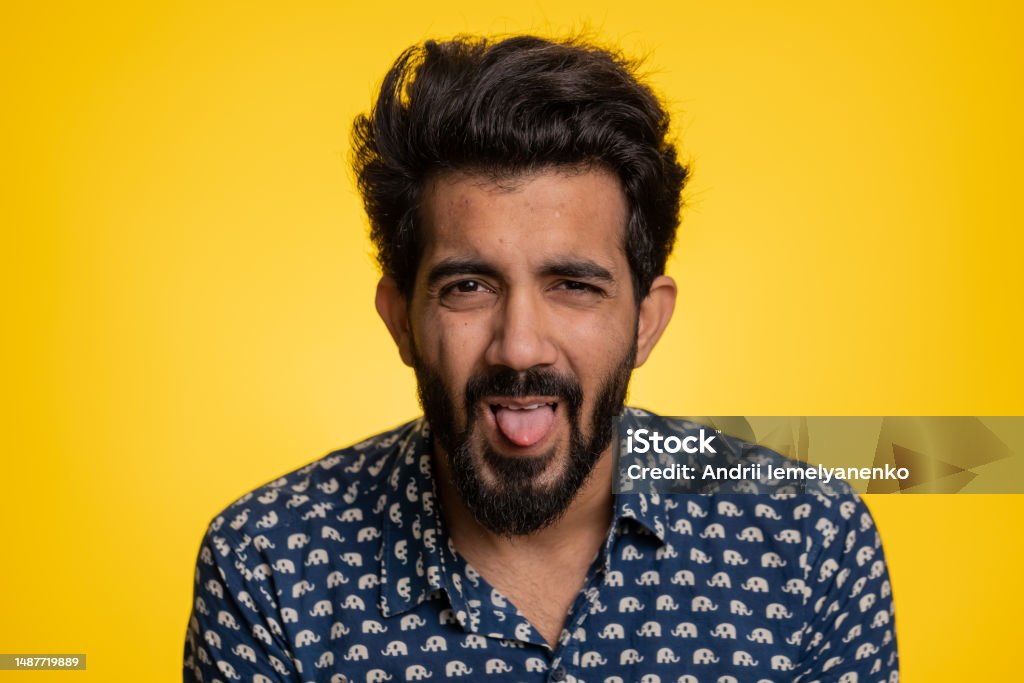 Cheerful Funny Bully Indian Man Showing Tongue Making Silly Faces