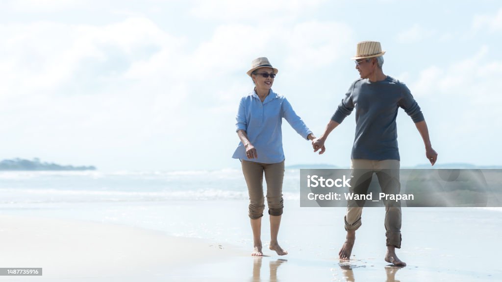 Asian Lifestyle Senior Couple Walking Chill On The Beach Happy In Love