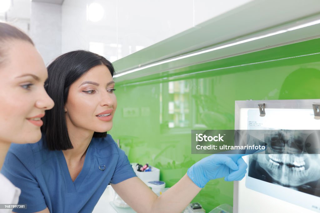 Beautiful Women Dentist Explains And Analyzes The Dental Xray Orthopan To A Patient Dental