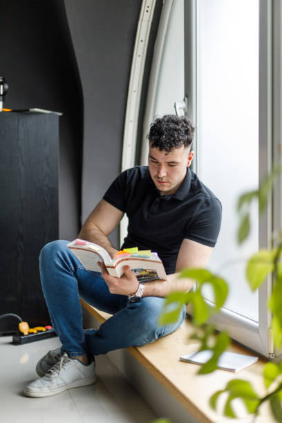 Free Stock Photo of Man Sitting on Window Sill Reading Book | Download ...