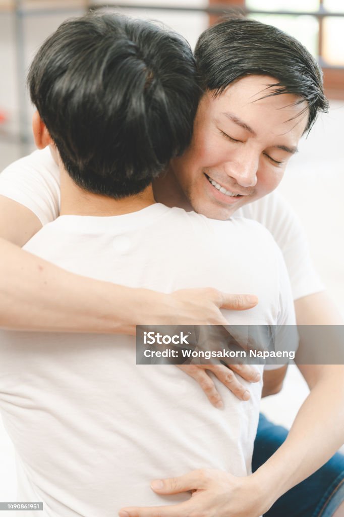 Happy Asian Gay Couple Hug Together On Sofa Asian Lgbt Couple Embracing