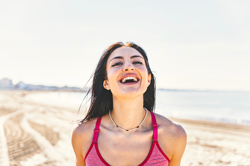 Happy Caucasian Young Sporty Woman Smiling At Camera Outdoors On The