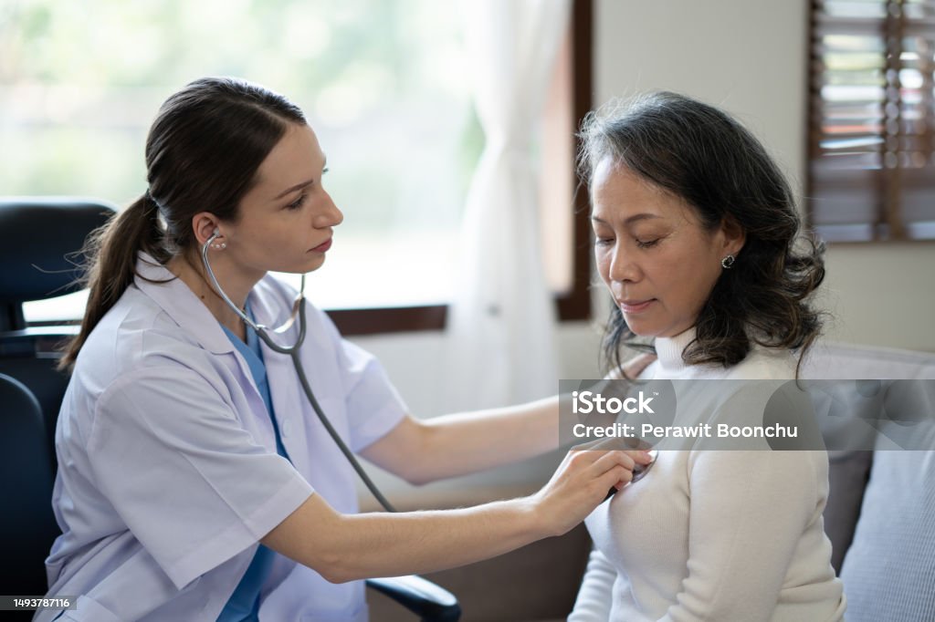 Caucasian Famale Doctor Sit On Chair Check Asian Senior Elderly Old