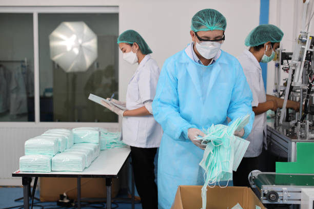 Free Stock Photo of Workers producing surgical masks in modern factory ...