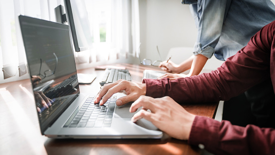 Programmer Writing Program Code With Two Monitors And Working On A New Software Or Hacker