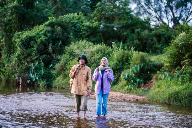 Free Stock Photo of A Man and a Woman Walking Along a River | Download ...