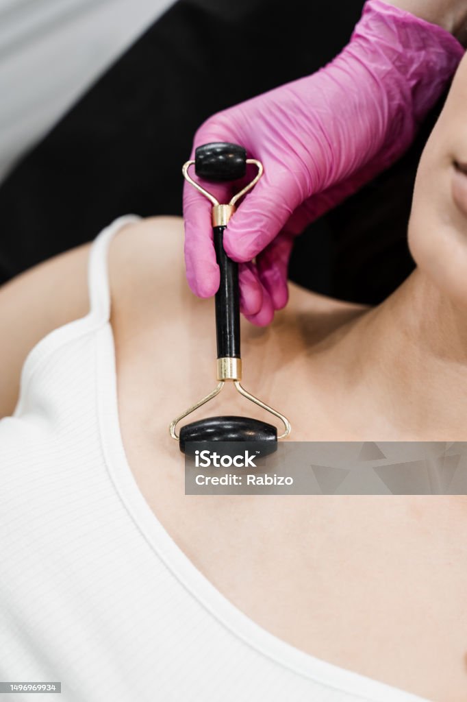 Facial Massage With Cosmetics Roller In Cosmetology Clinic Process Of