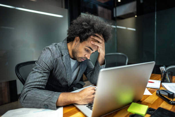 Free Stock Photo of Young businessman frustrated at his desk | Download ...