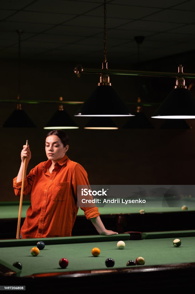 Girl Player Plays Billiards In A Club Stands Thinking Near The Pool