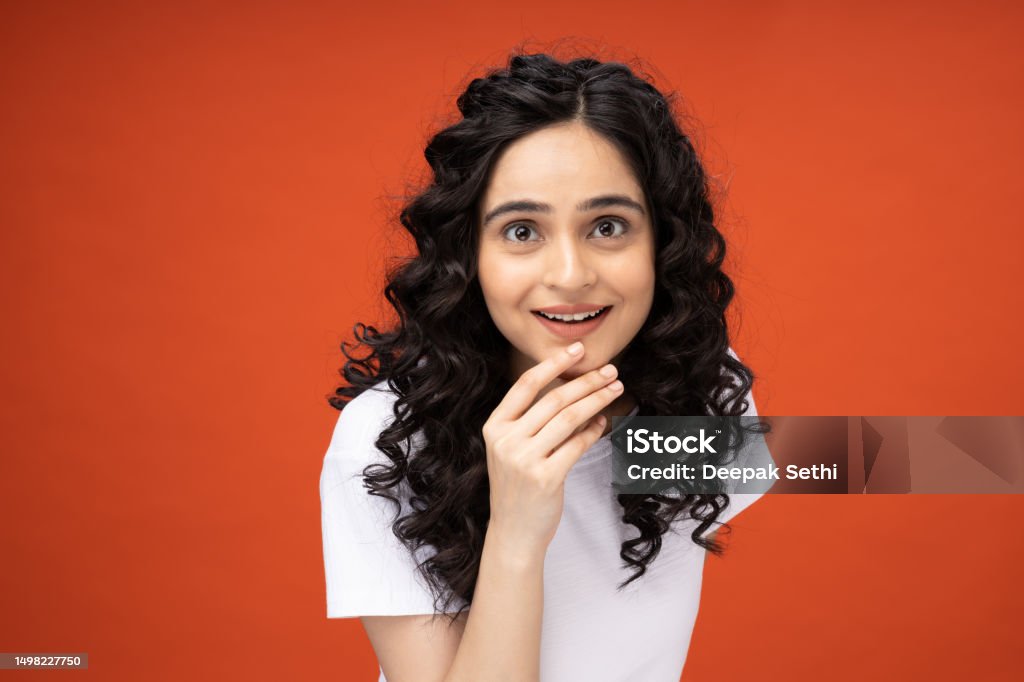 Portrait Of Beautiful Girl Wearing White Tshirt Isolated Over Orange