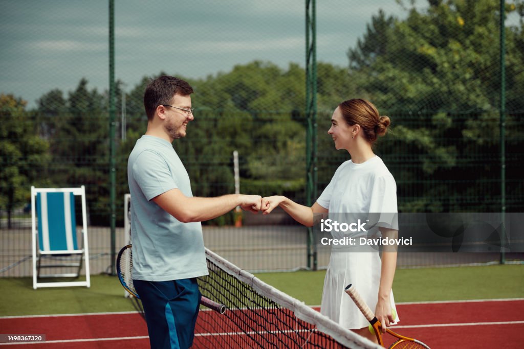 Young Tennis Players Giving Fist Bump With Fist Before Playing Court