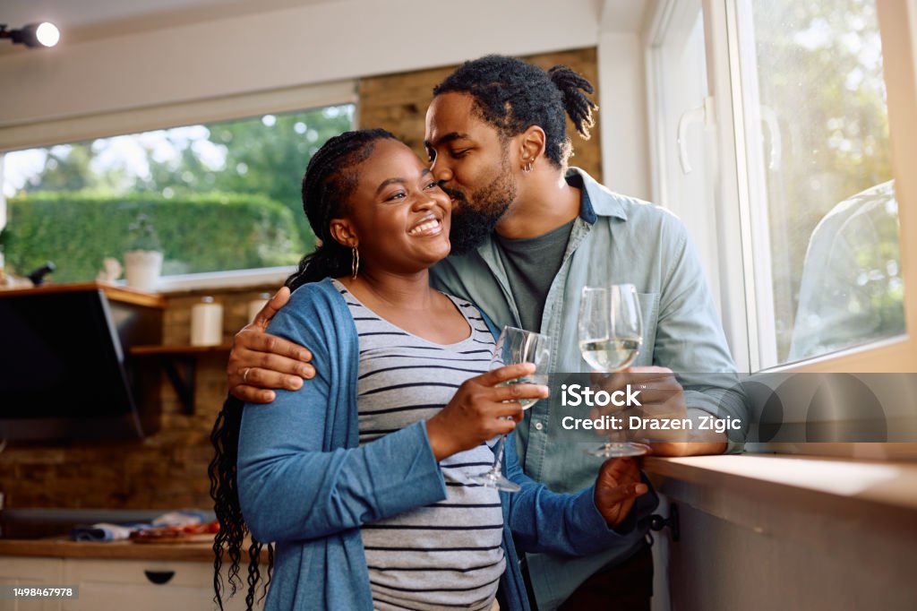 Happy Black Couple Enjoying In Their Love And A Glass Of Wine At Home